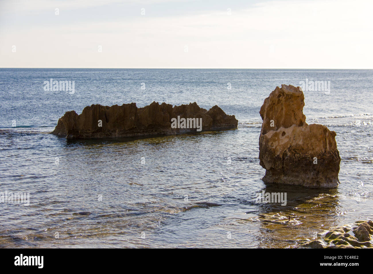 Las Rotas rocky beach in Denia, Spain at sunset Stock Photo - Alamy