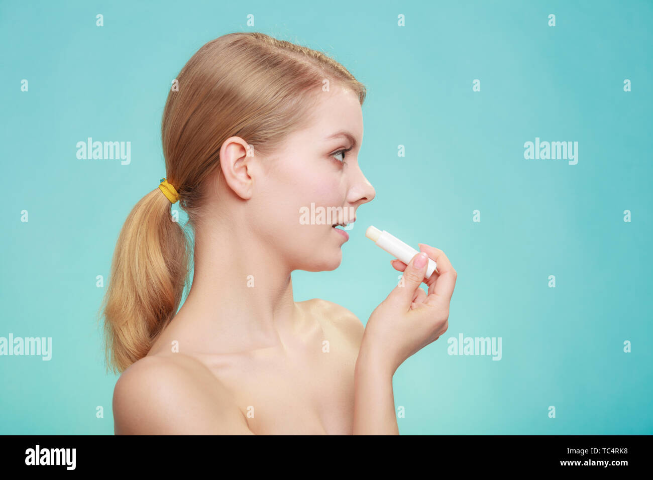 Female putting applying lip balm moisturizing balsam. Girl taking care ...