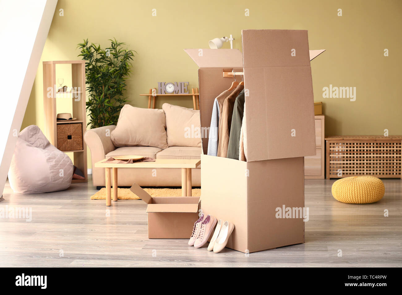Wardrobe boxes with clothes in room Stock Photo - Alamy