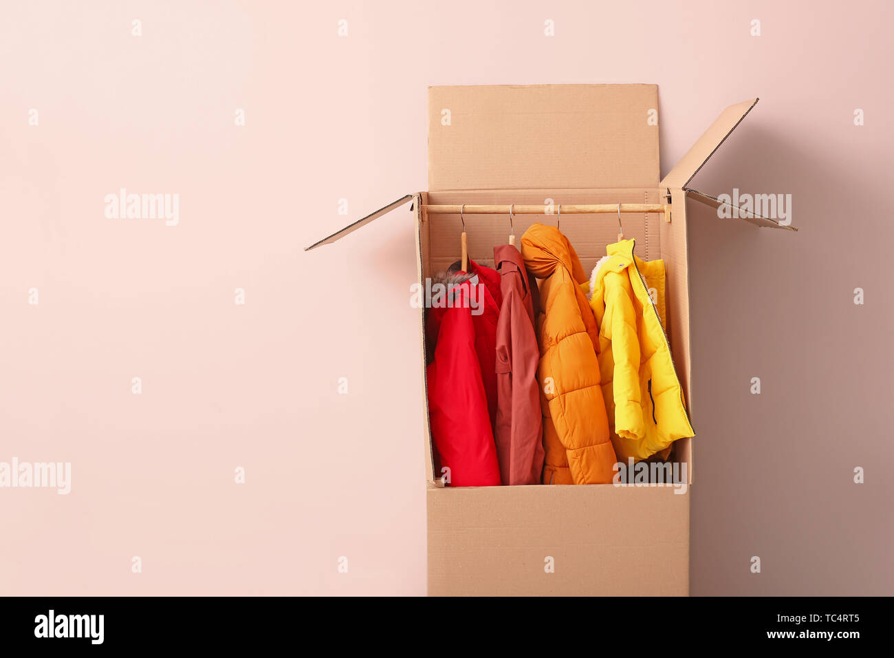 Wardrobe box with clothes on white background Stock Photo - Alamy