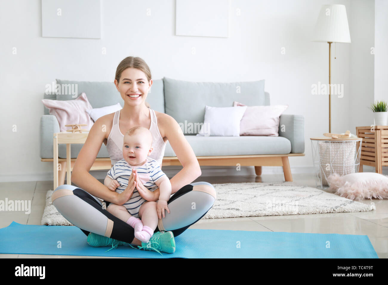 Mother training with cute little baby at home Stock Photo - Alamy