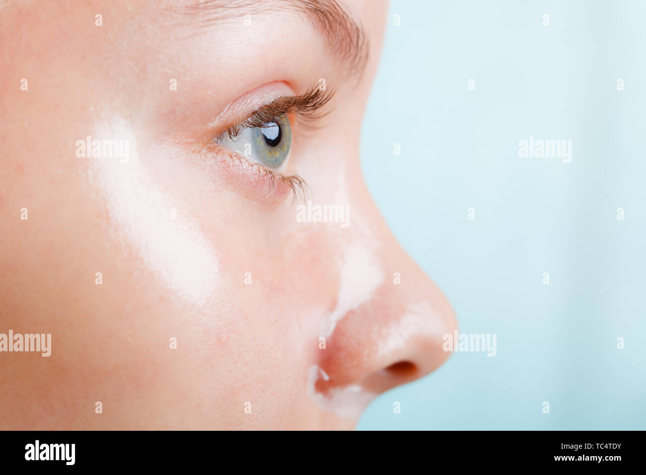 Close up young woman in facial peel off mask, part of face. Peeling ...