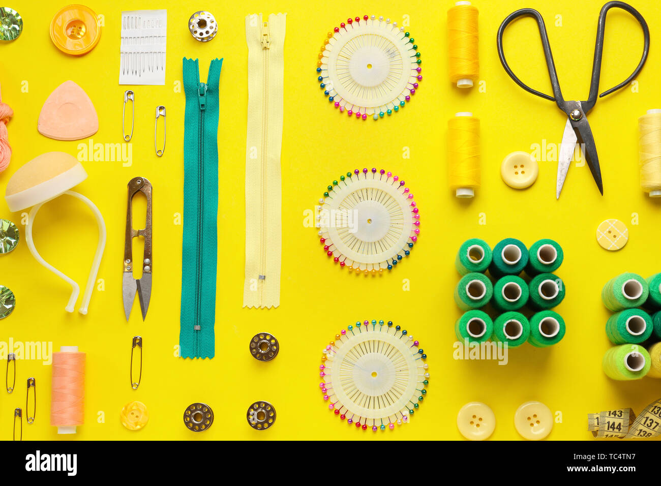 Set of sewing threads and accessories on color background Stock Photo ...