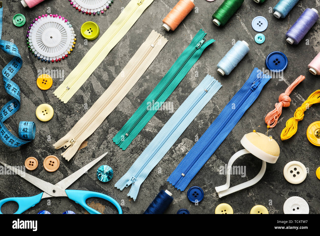 Set of sewing threads and accessories on grunge background Stock Photo ...