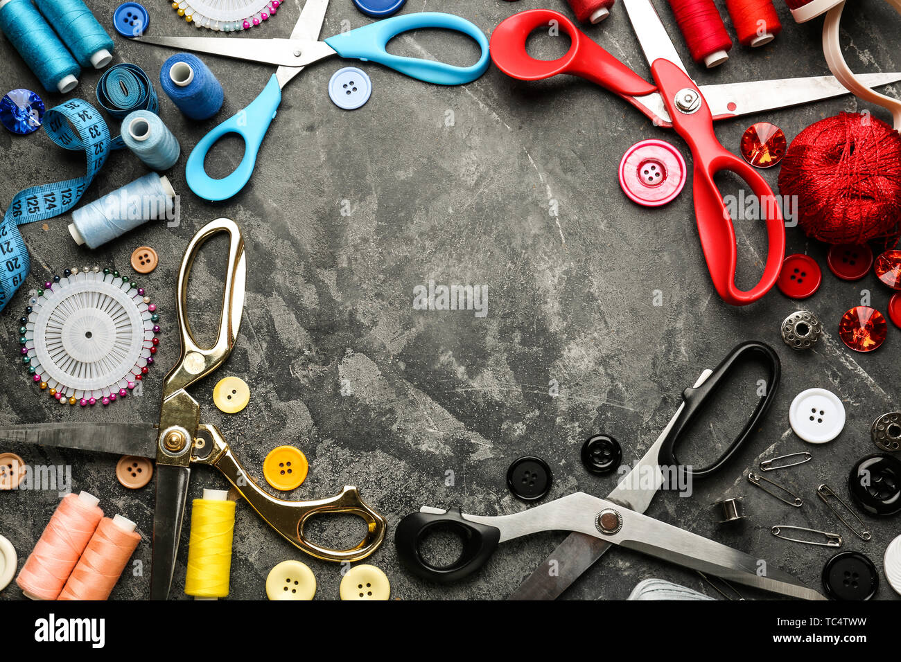 Frame made of sewing threads and accessories on grunge background Stock ...