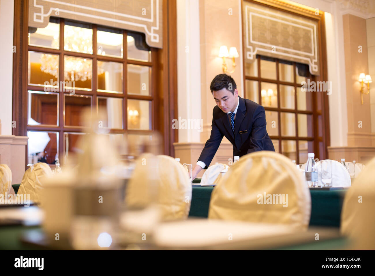 people setting table in luxury dining room Stock Photo - Alamy