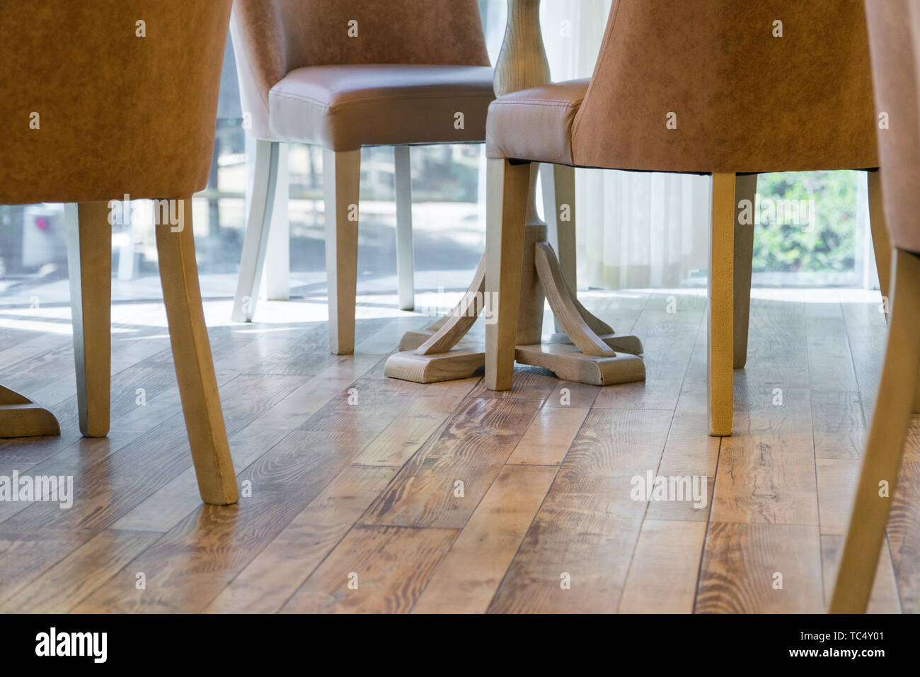 legs of chairs on the wooden floor of the restaurant, close-up Stock ...