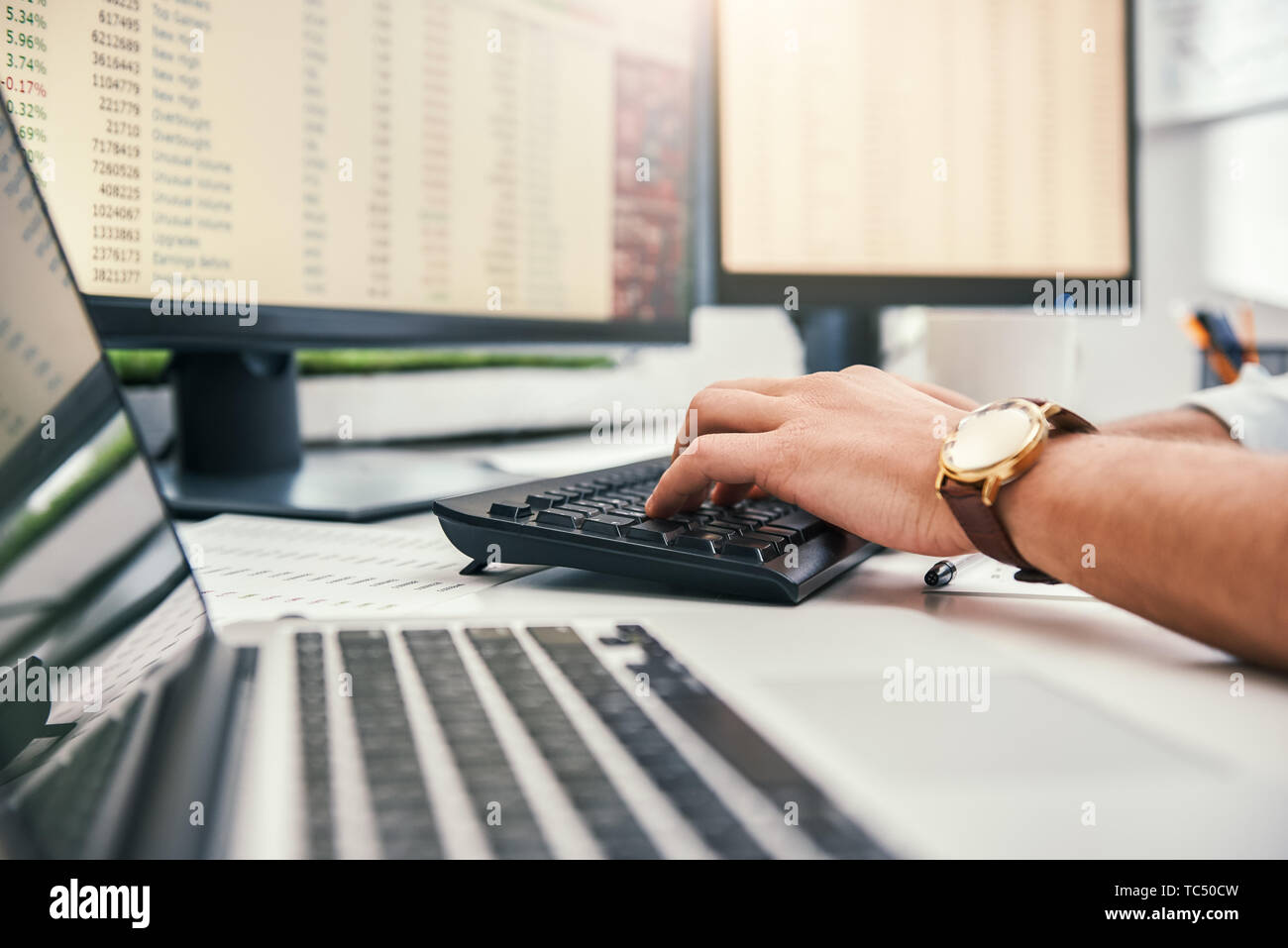 Trading online. Cropped photo of male trader's hands with watch on his ...
