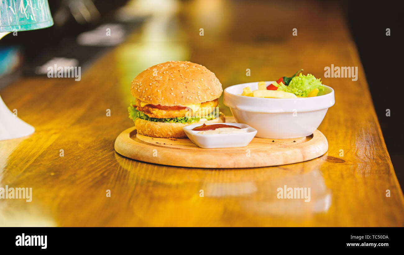 Delicious burger with sesame seeds. Burger with cheese meat and salad ...