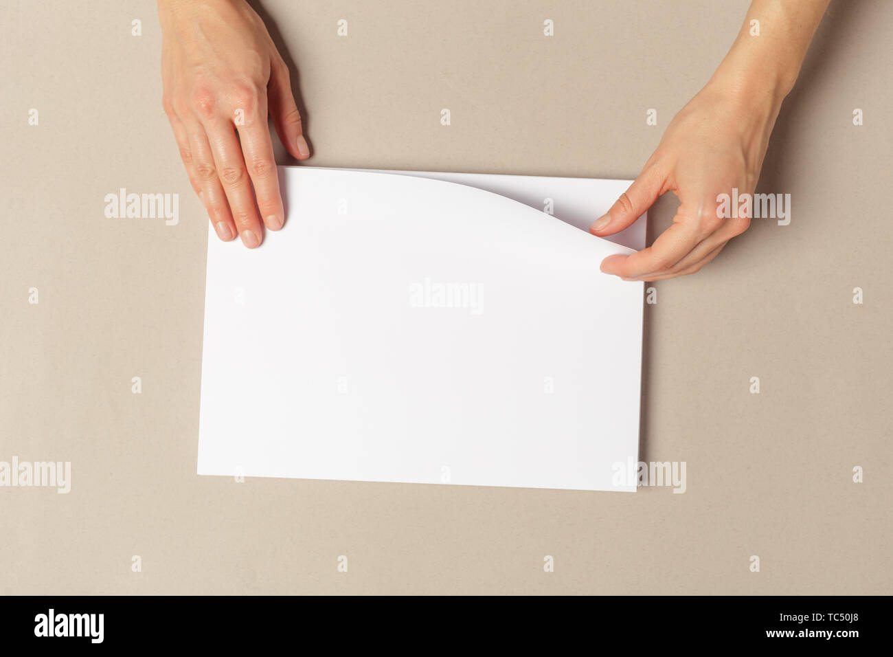 Hand holding papers a4 size Stock Photo - Alamy