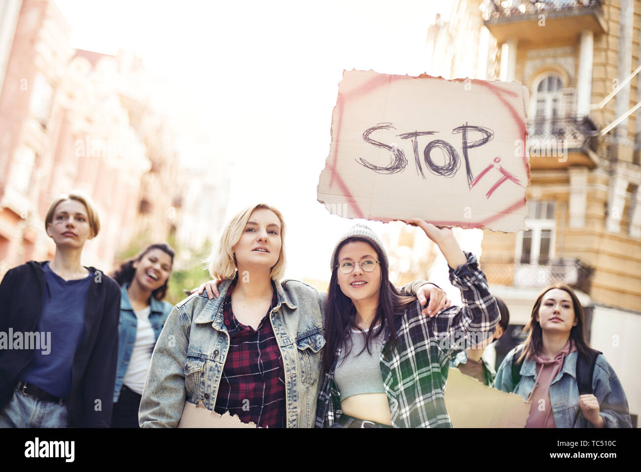 Stop violence against women. Two young women are holding a banner with ...