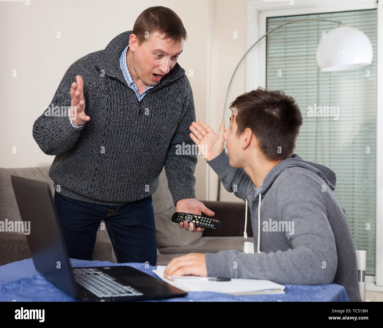 Father unhappy with how teenage son learns Stock Photo - Alamy