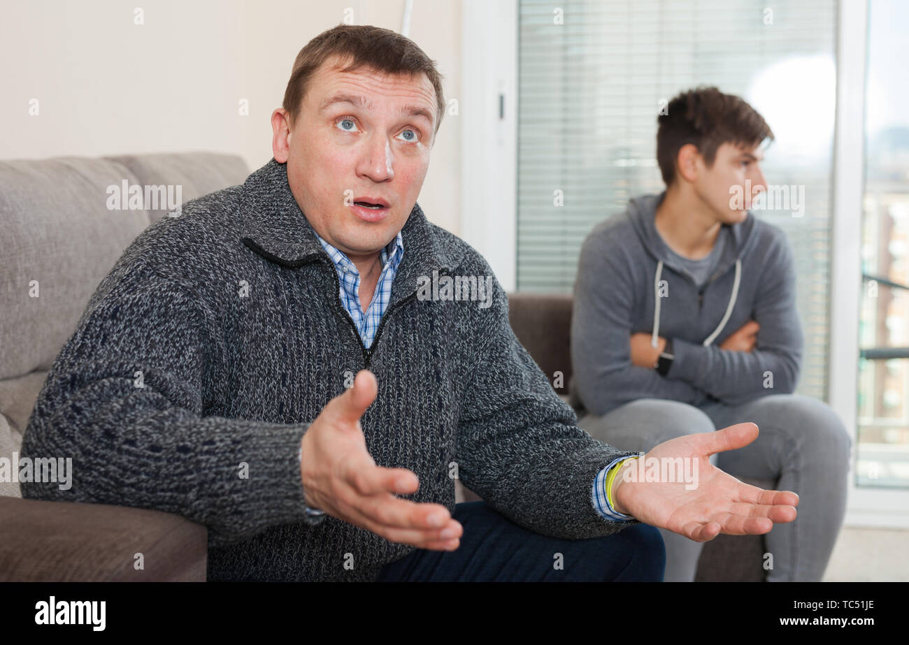 Outraged father unhappy with his son teenager Stock Photo - Alamy