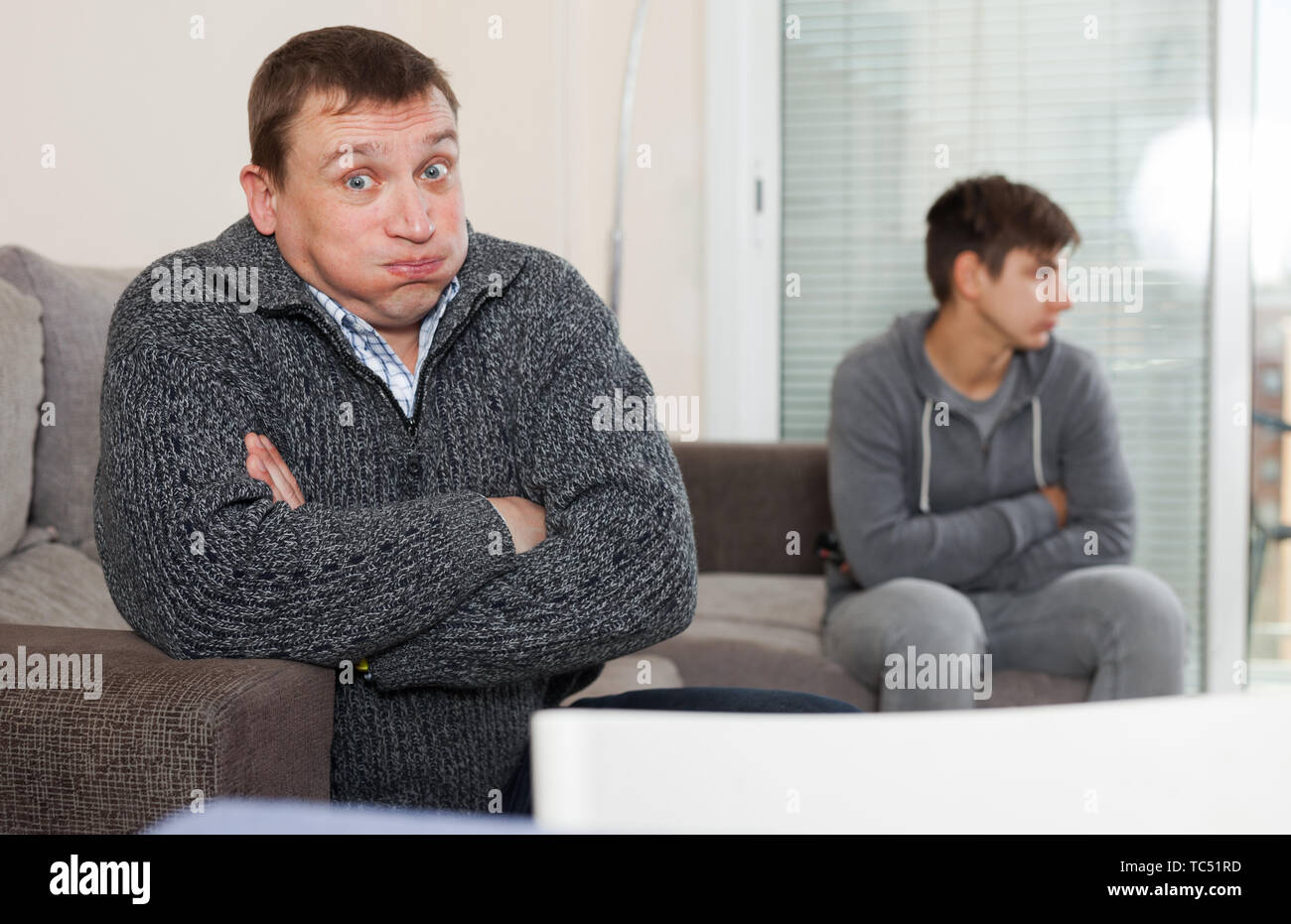 Outraged father unhappy with his son teenager Stock Photo - Alamy