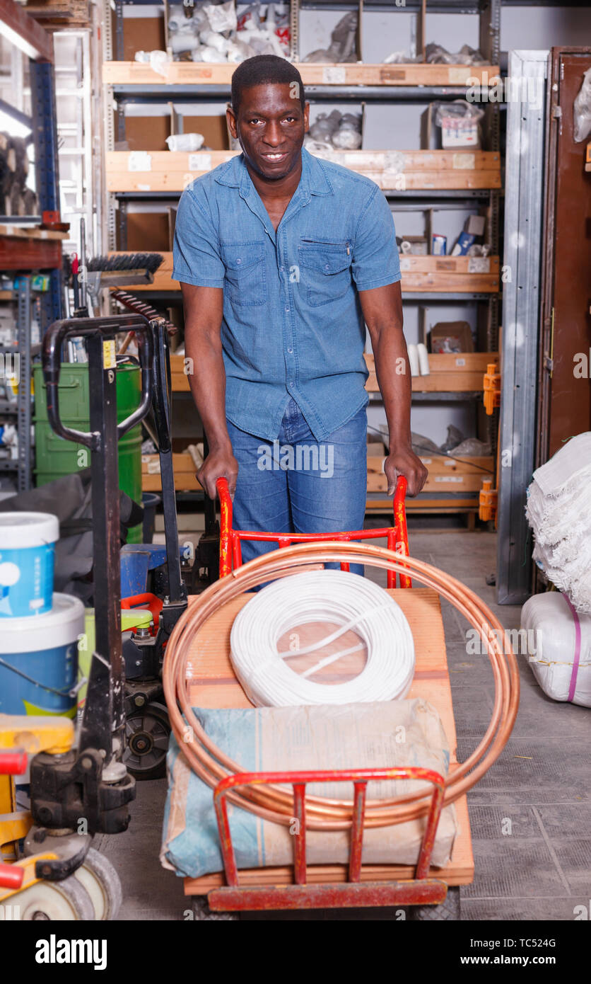 Focused African American diligent positive cheerful smiling carrying ...