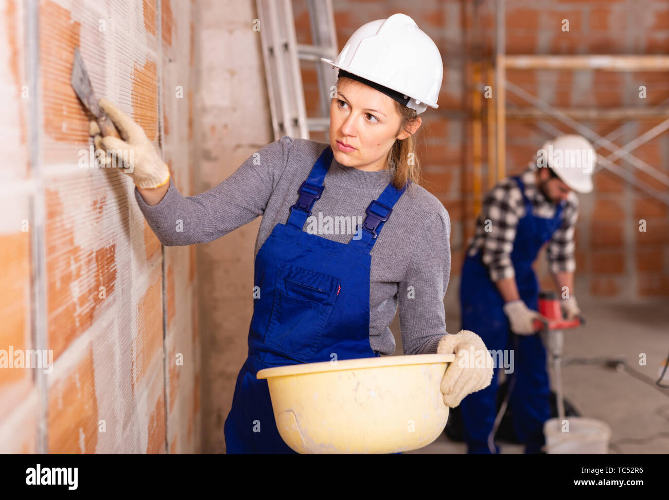 Portrait of two professional builders in process of repair at private ...