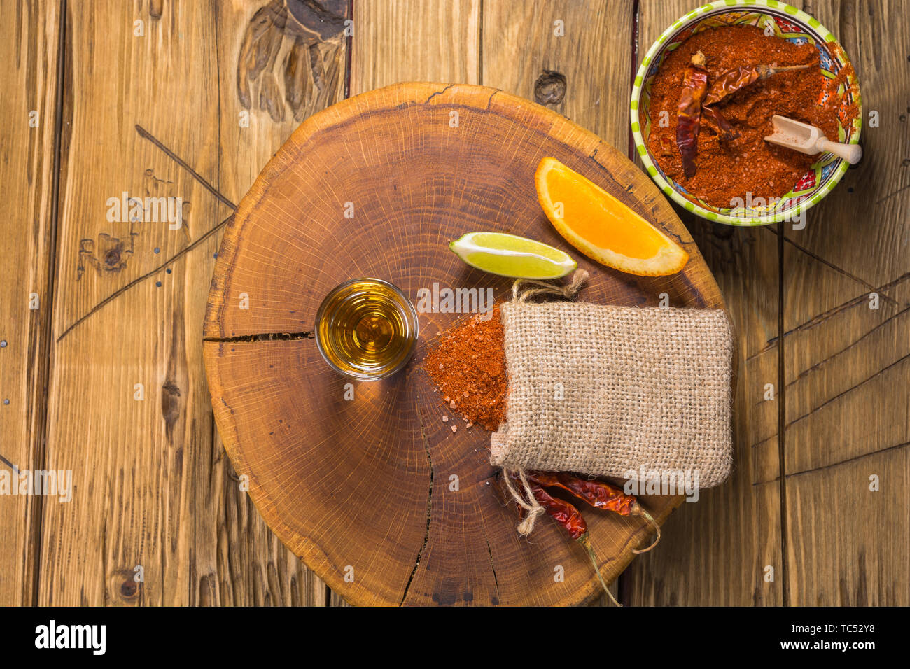 Mezcal shot mexican drink with orange and lime slices, chili and worm ...