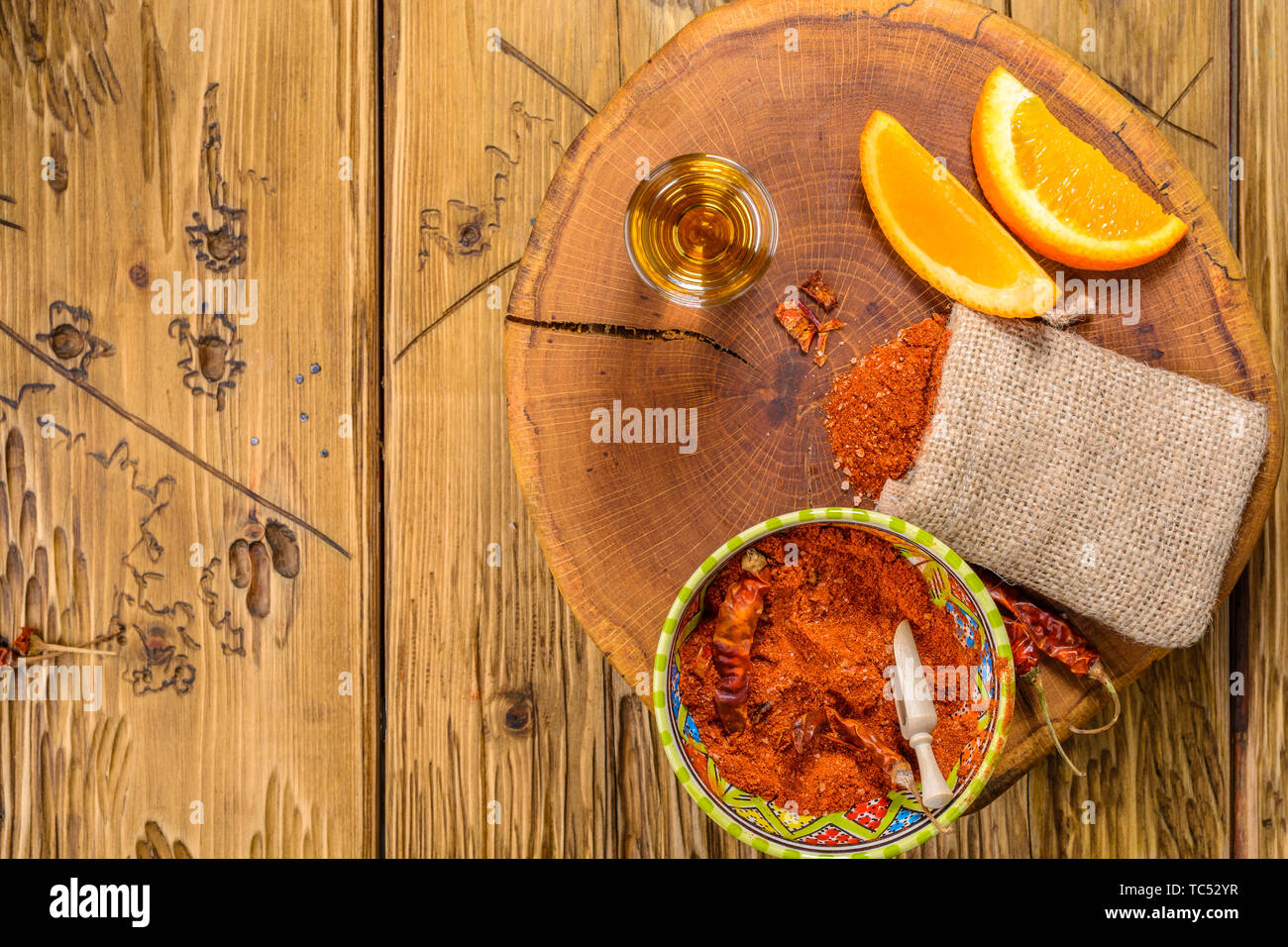 Mezcal shot mexican drink with orange slices, chili pepper and worm ...
