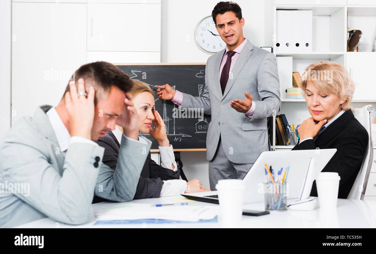 Angry boss blowing up his subordinates for mistakes in work Stock Photo ...