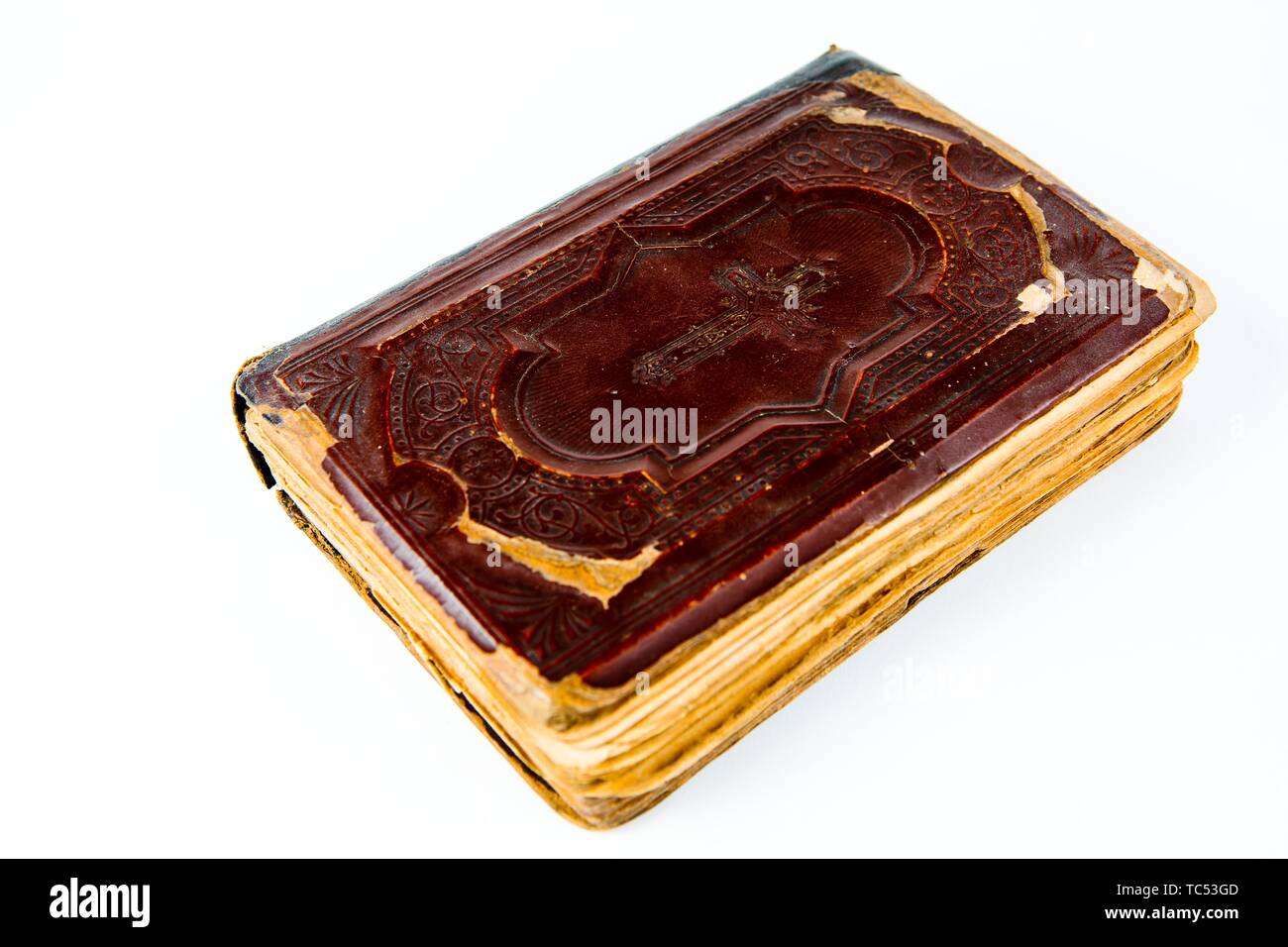 Vintage book with claret leather cover with christian cross, on white ...