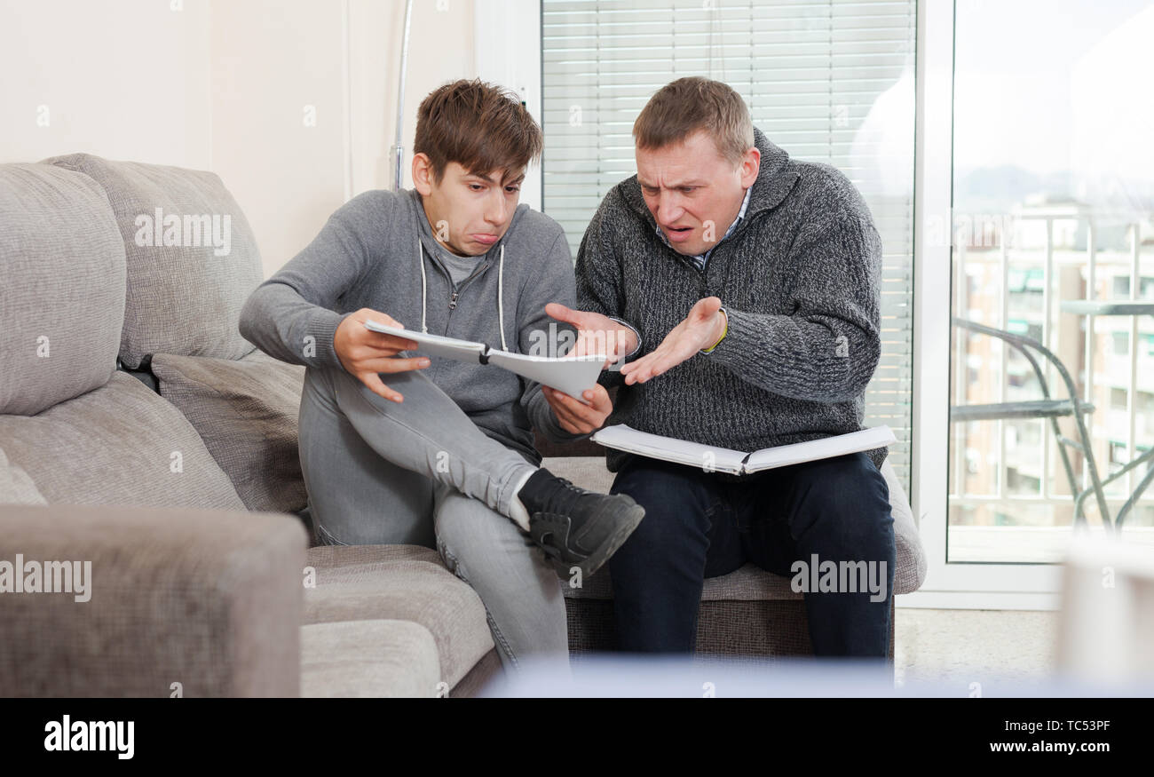 Father and teen son solve school assignment together Stock Photo - Alamy