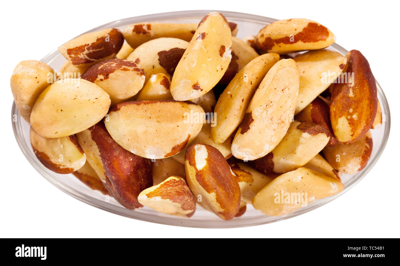 Top view of glass bowl with shelled roasted Brazil nut seeds. Isolated ...