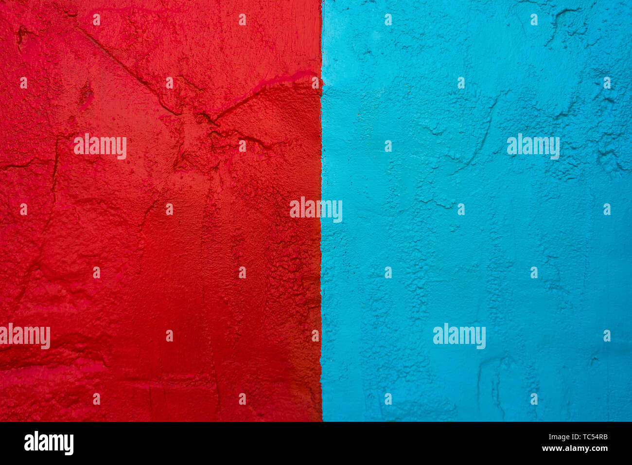Textured wall painted in red and turquoise bright and contrasting ...