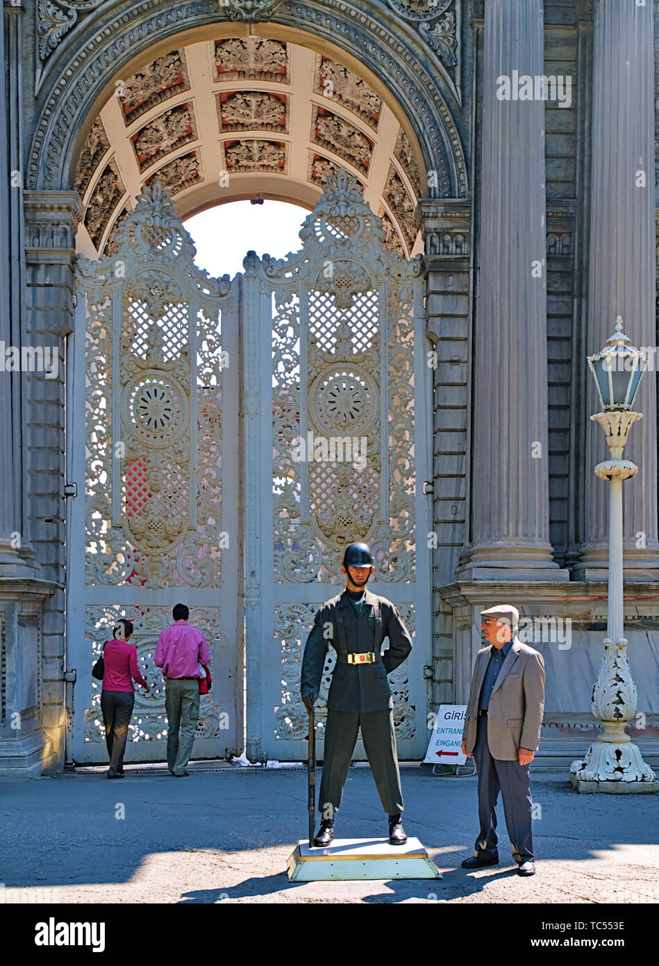 Istanbul, Turkey - 05/24/2010: Old man staring at soldier guarding gate ...