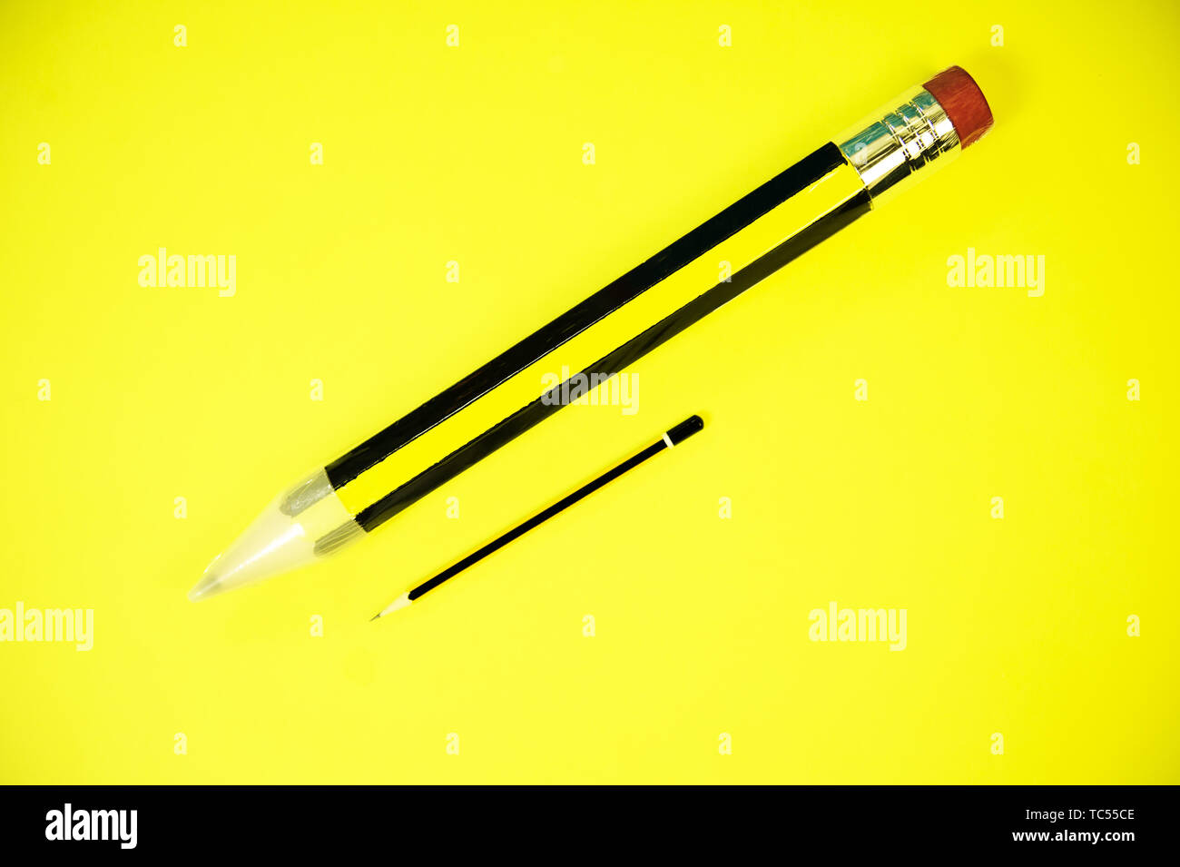a giant pencil and a little ordinary pencil Stock Photo - Alamy