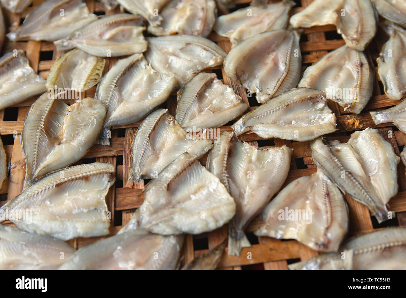 Dried fish on Bamboo sieve with sunny Stock Photo - Alamy