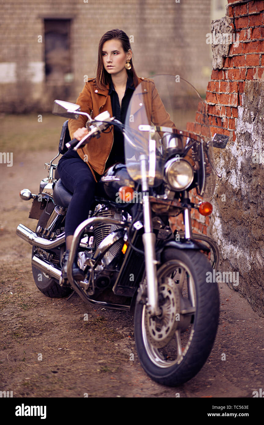 Portrait of beautiful young woman posing with motorcycle Stock Photo ...