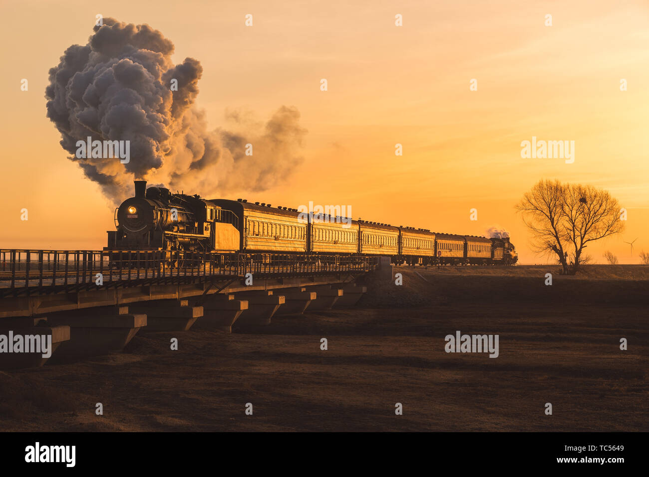 Steam train, railway, sunset, sunrise Stock Photo - Alamy