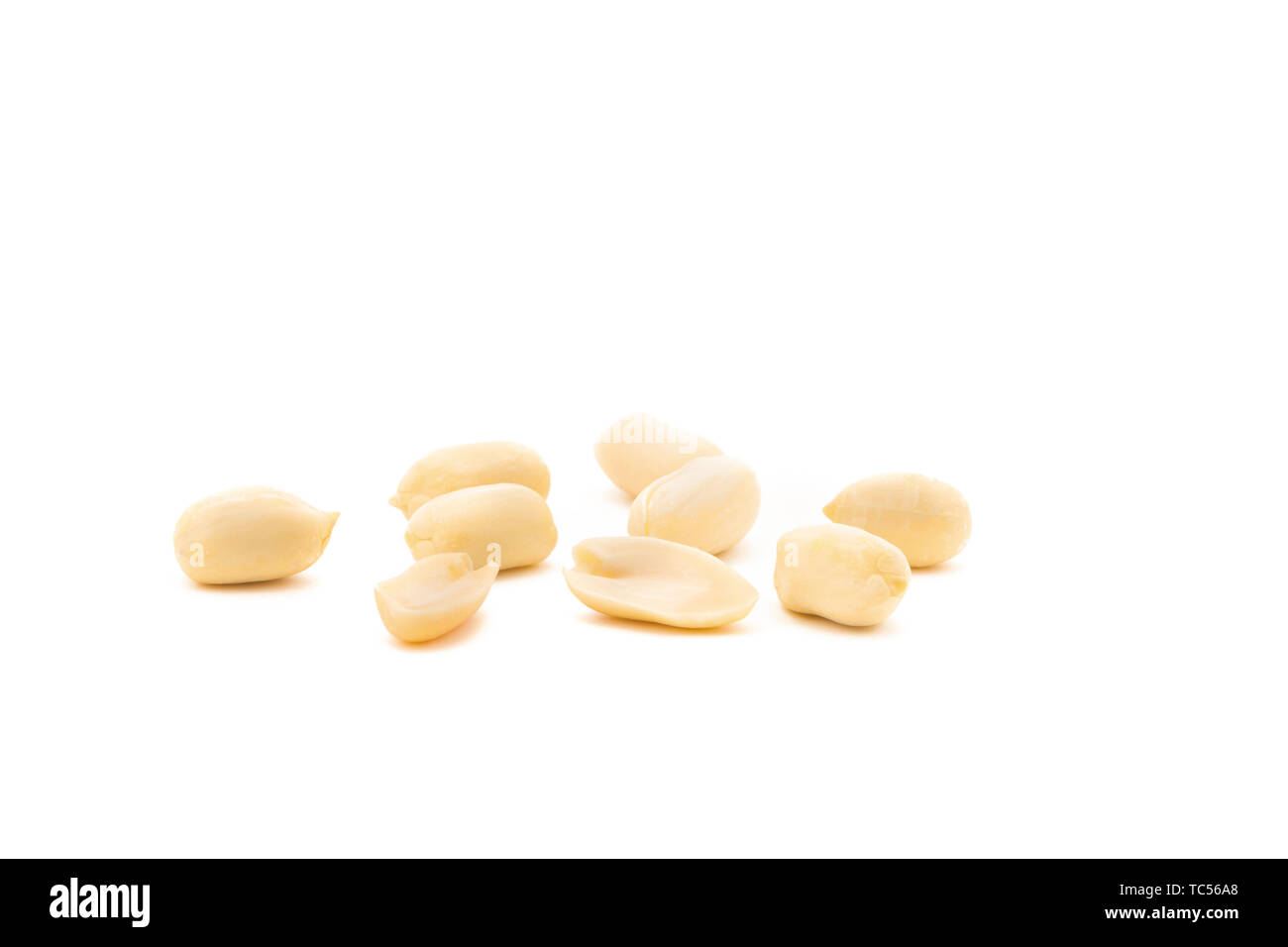 Peeling peanuts on white background Stock Photo - Alamy
