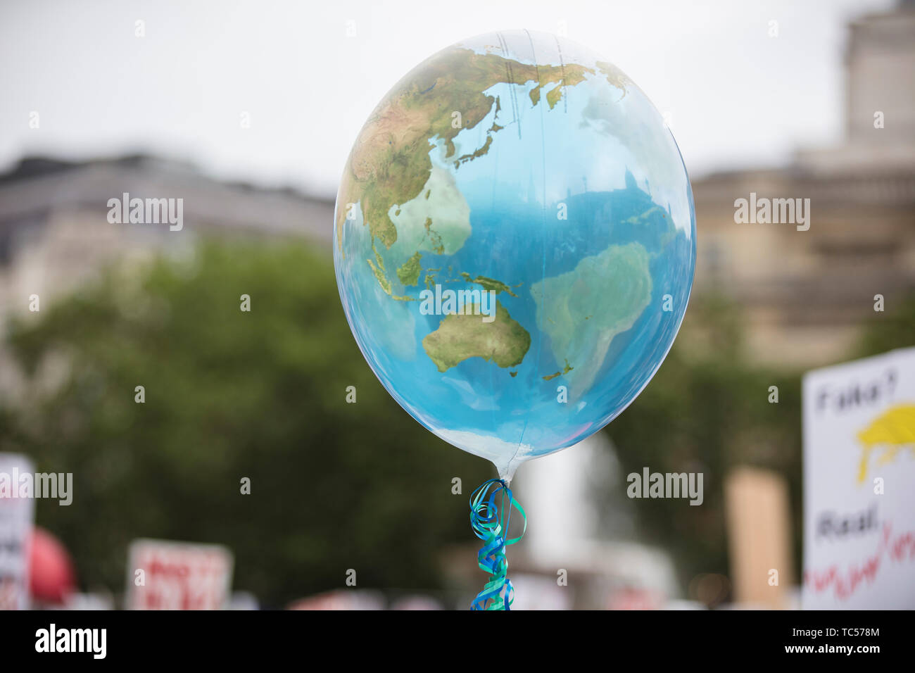 An earth shaped balloon floating on a string. Climate and environment ...
