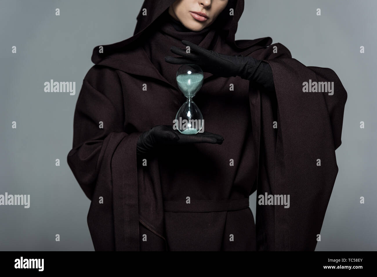 Woman holding sand timer hi-res stock photography and images - Alamy