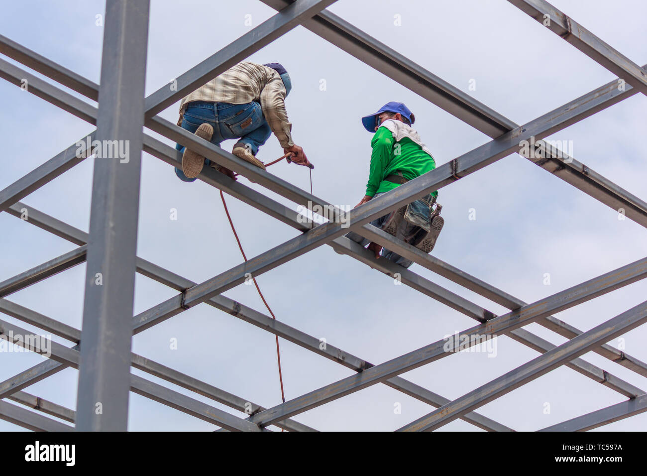 Welder welding fabricated construction in building, Welding process by ...