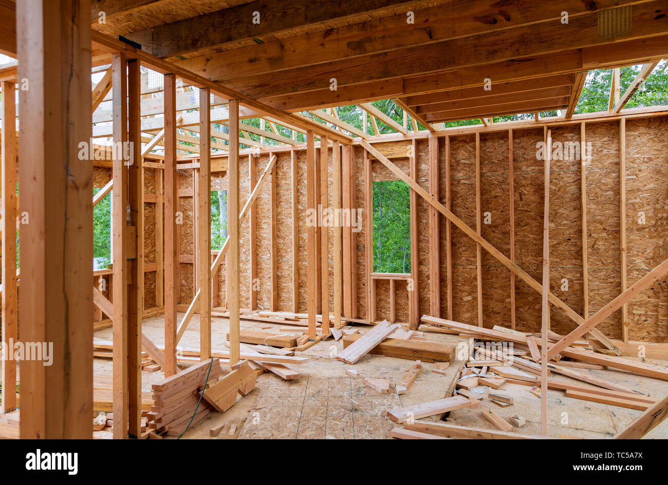 Close-up of beam built home under construction and blue sky with wooden ...