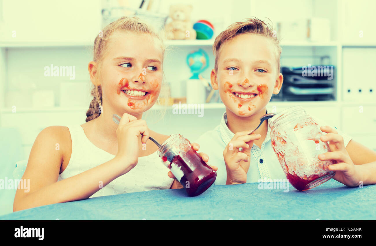 Girl and boy are eating jam at lunch time Stock Photo - Alamy