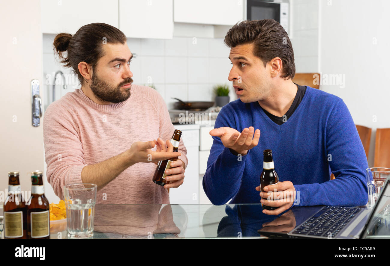 Two men friends are talking and drinking beer Stock Photo - Alamy