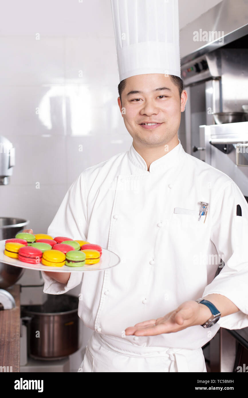 young chinese man chelf making food in modern kitchen Stock Photo - Alamy