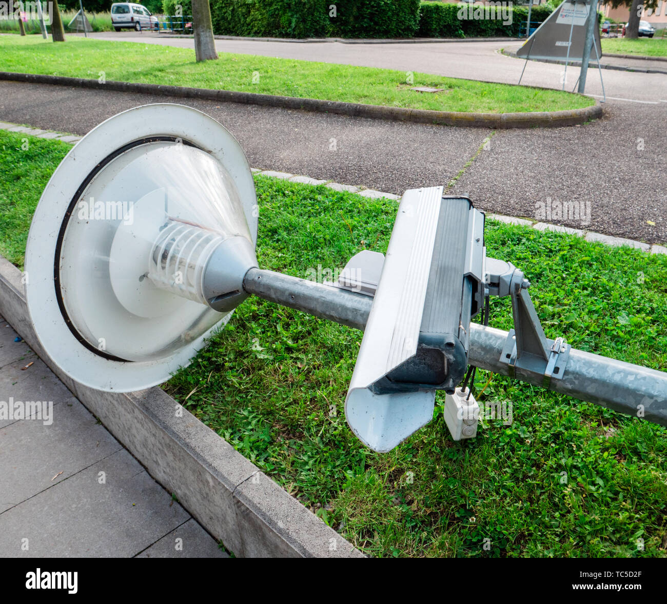 Damaged surveillance camera on street lamp pole on the ground ...