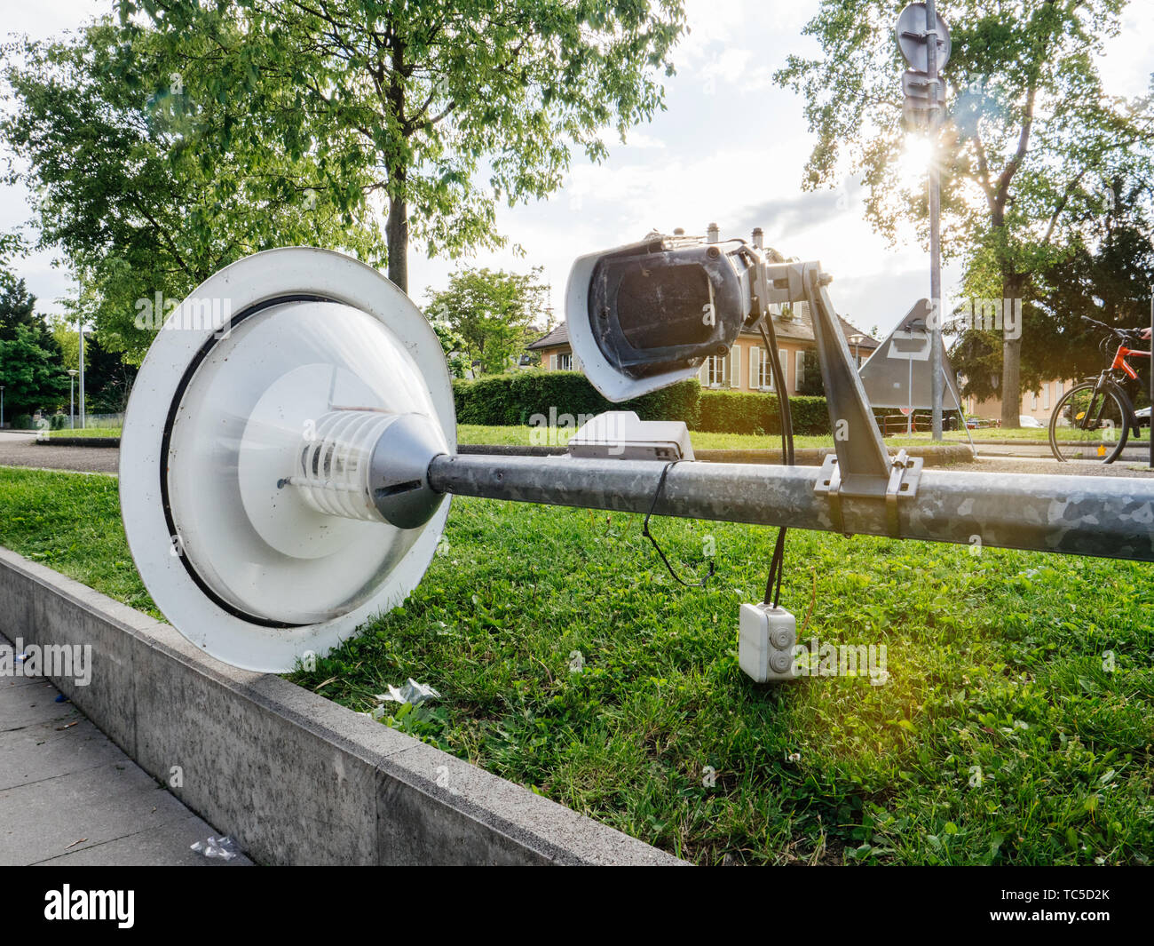 Damaged surveillance camera on street lamp pole on the ground ...