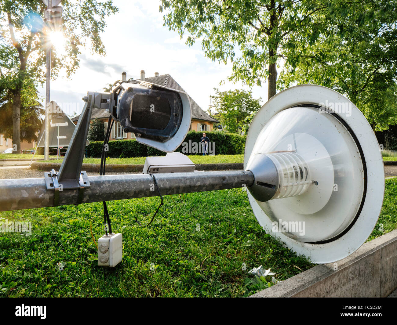 Detail of damaged surveillance camera on street lamp pole on the ground ...