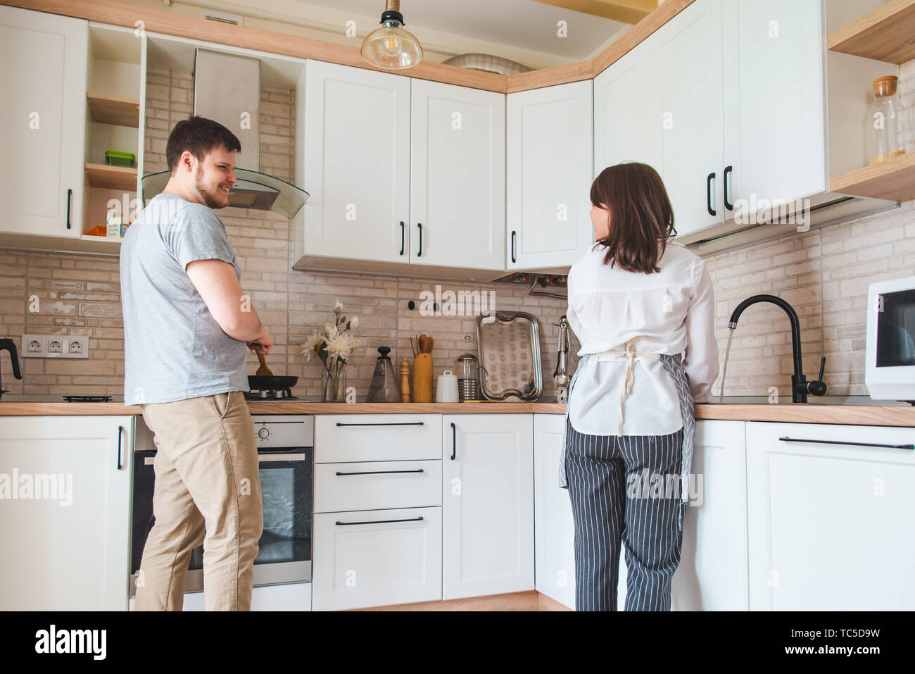 couple cooking on kitchen washing dishes. home lifestyle Stock Photo ...