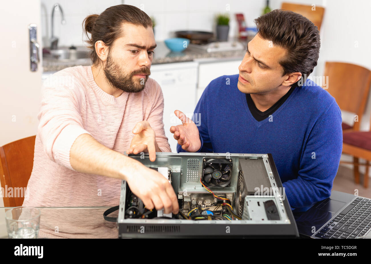 Two men repairing a desktop computer Stock Photo - Alamy