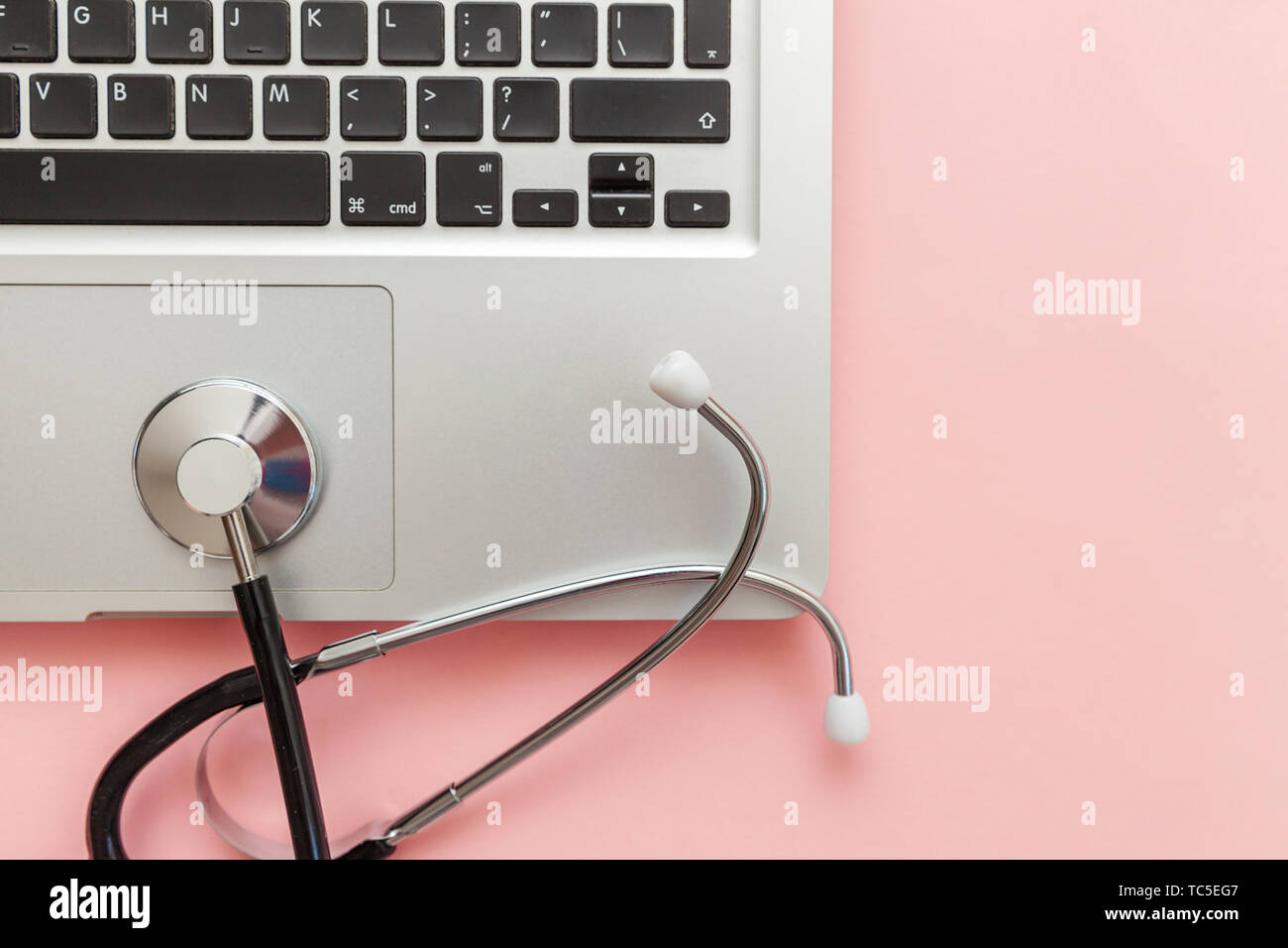 Stethoscope keyboard laptop computer isolated on pink background ...