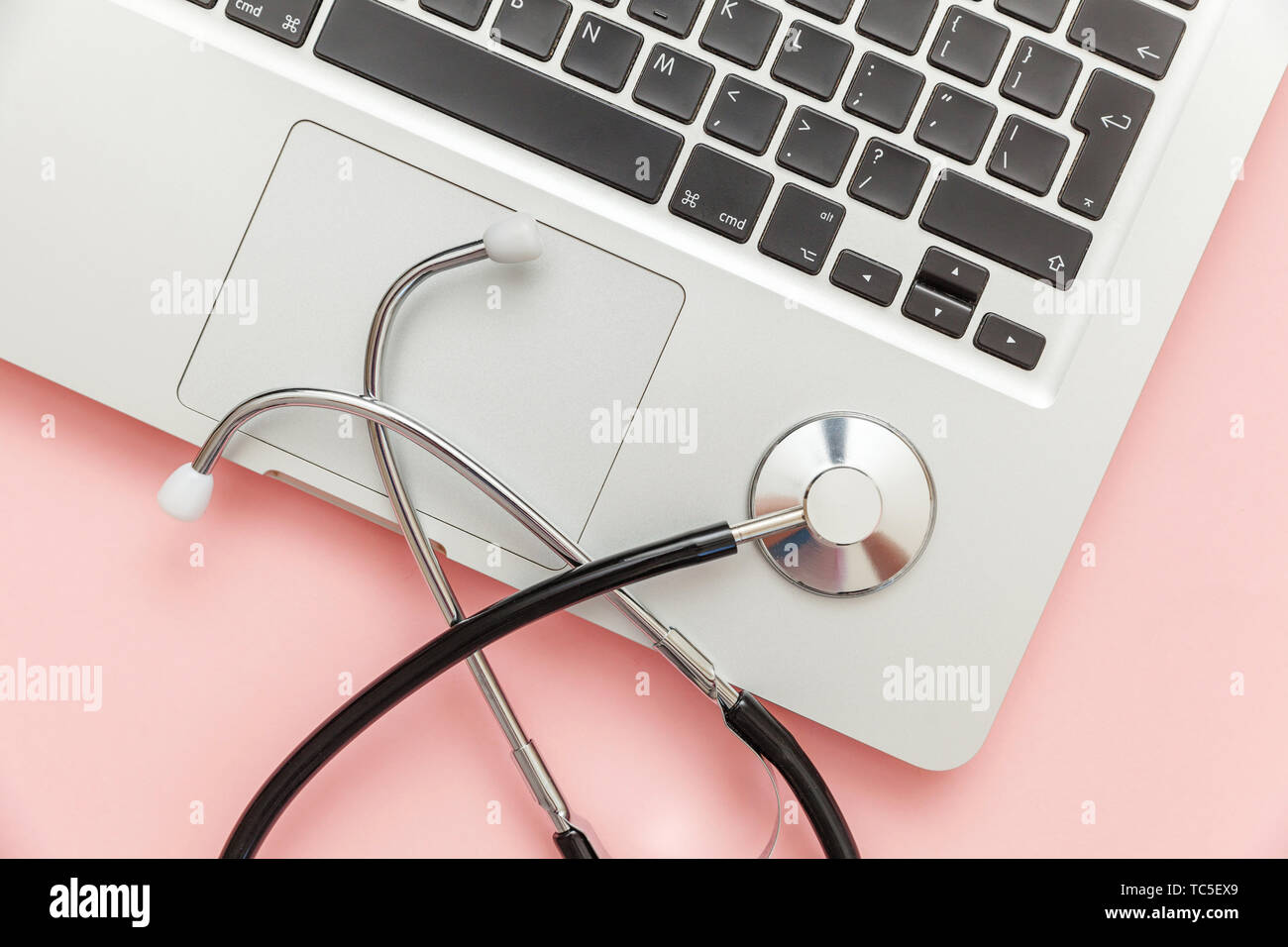 Stethoscope keyboard laptop computer isolated on pink background ...