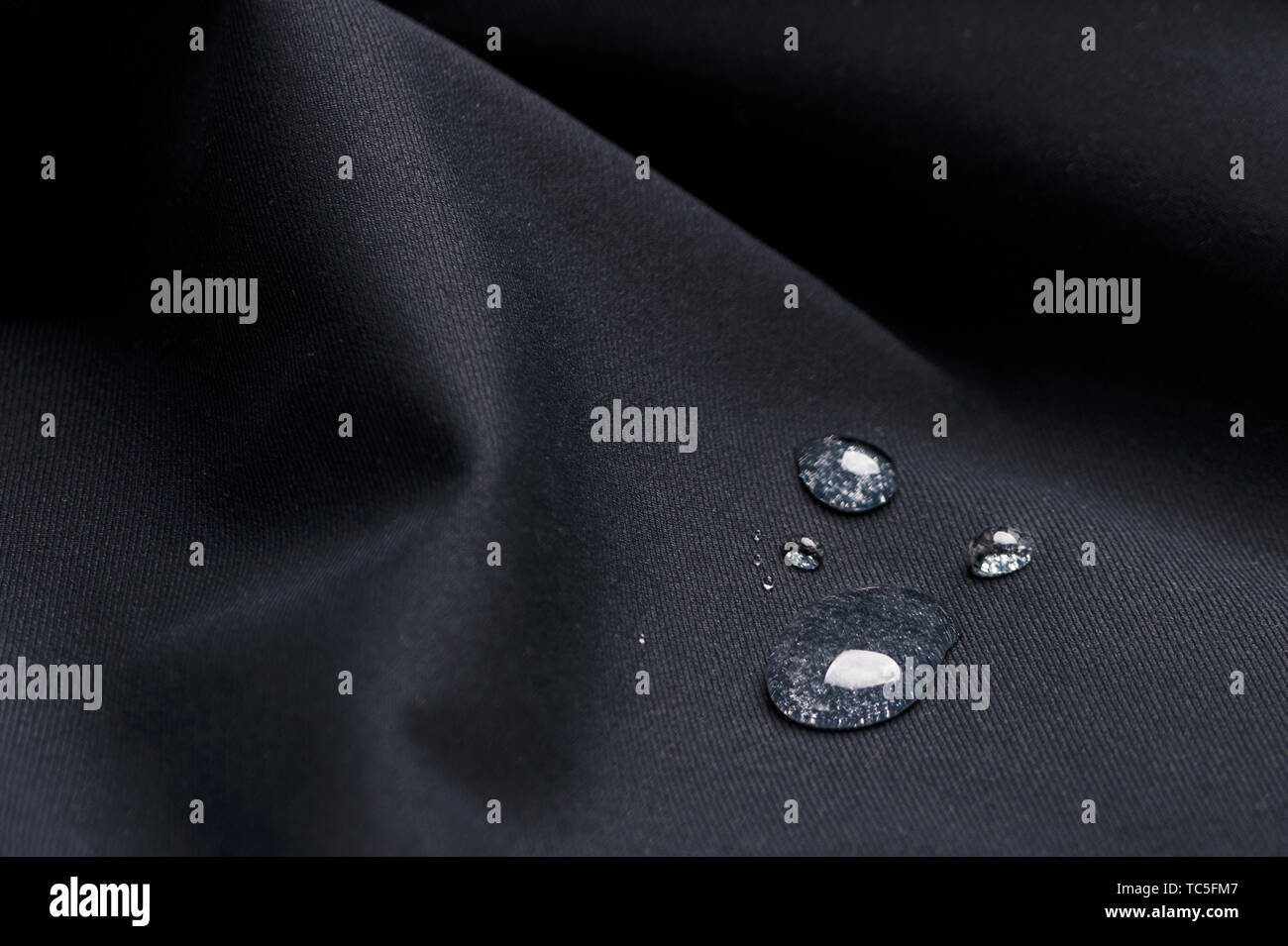 Shiny beads of water falling on waterproof fabric Stock Photo - Alamy