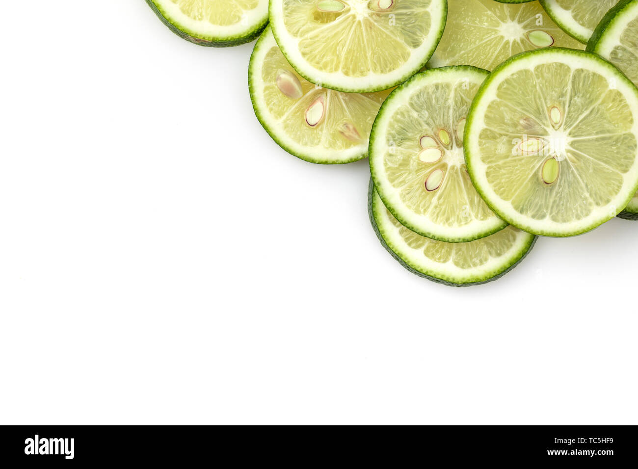 Green lemon slices on white background Stock Photo - Alamy