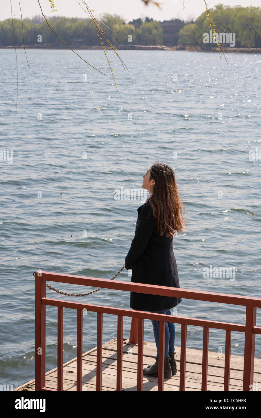 Asian girl's back and side face in spring travel Stock Photo - Alamy